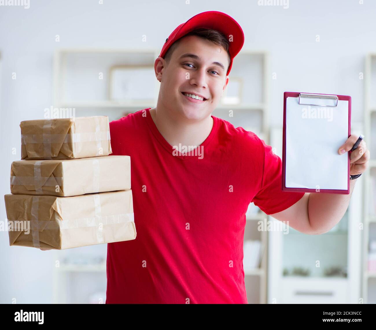 Post man delivering a parcel package Stock Photo - Alamy