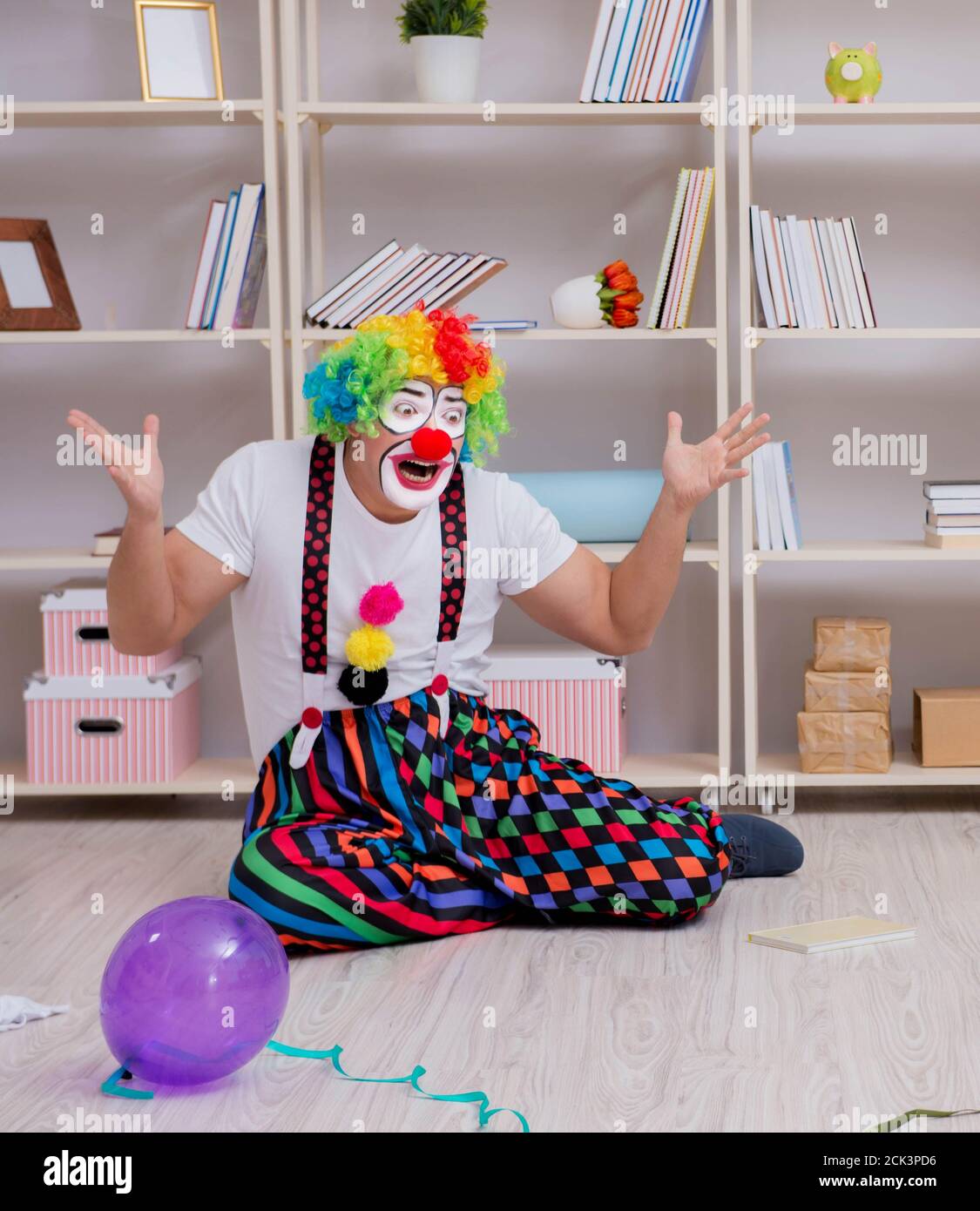 Drunk clown celebrating having a party at home Stock Photo - Alamy