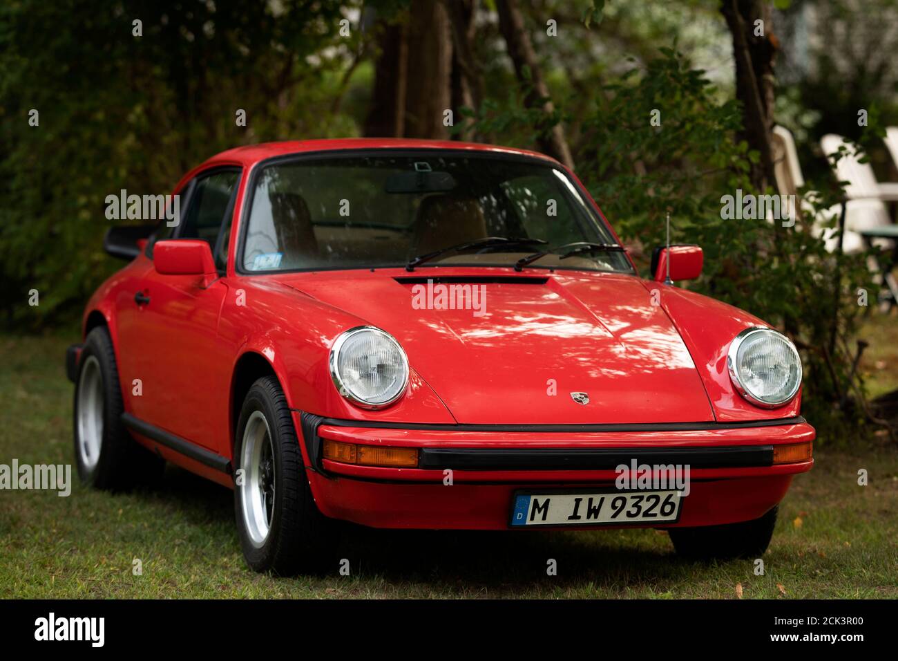 A red Porsche sports car with a German license plate spotted in ...