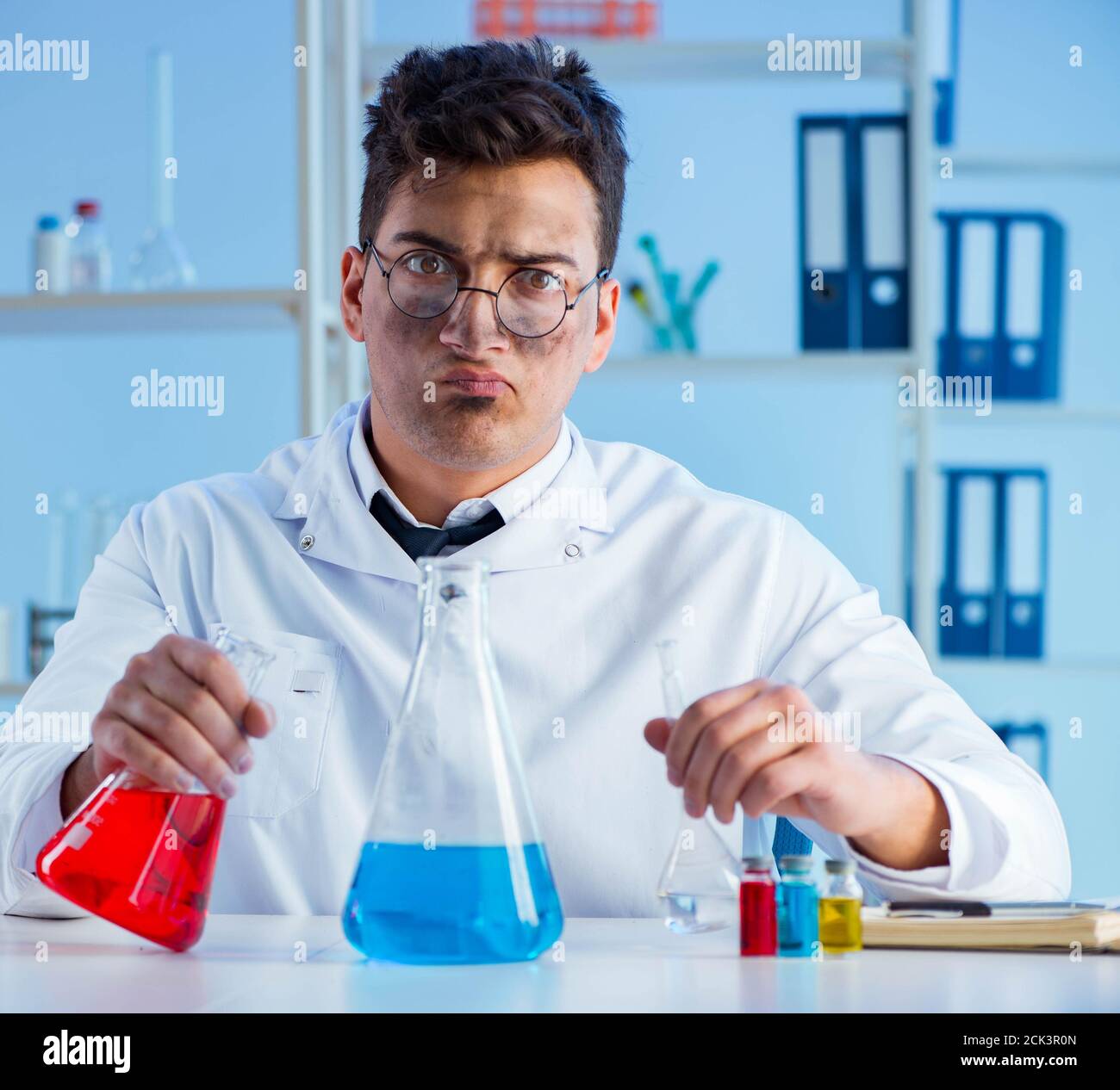 Funny mad chemist working in a laboratory Stock Photo - Alamy