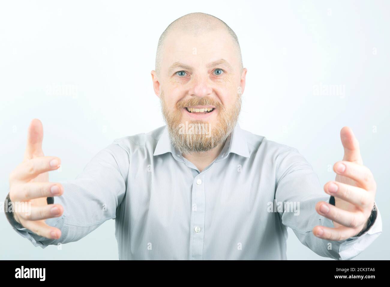 Bearded man stretches his arms forward Stock Photo - Alamy