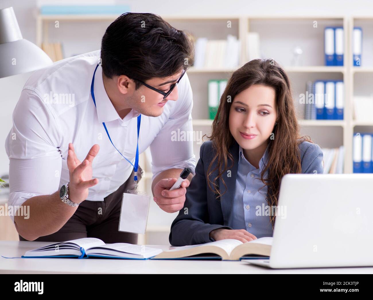 The teacher explaining to student at lecture Stock Photo - Alamy