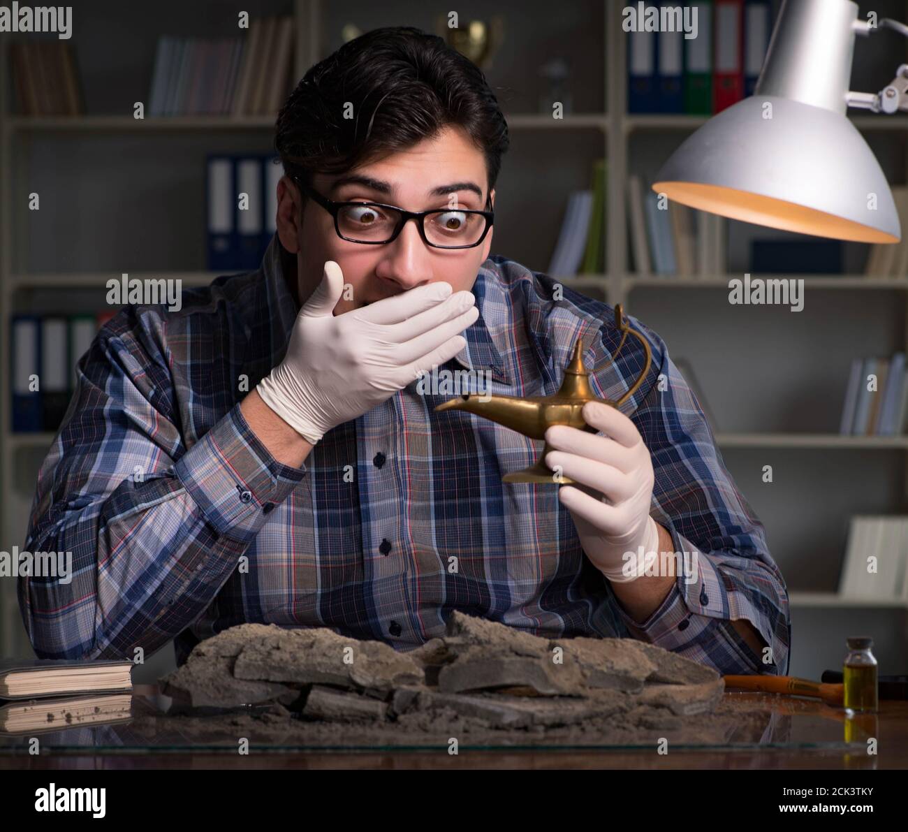 The archeologist working late night in office Stock Photo - Alamy