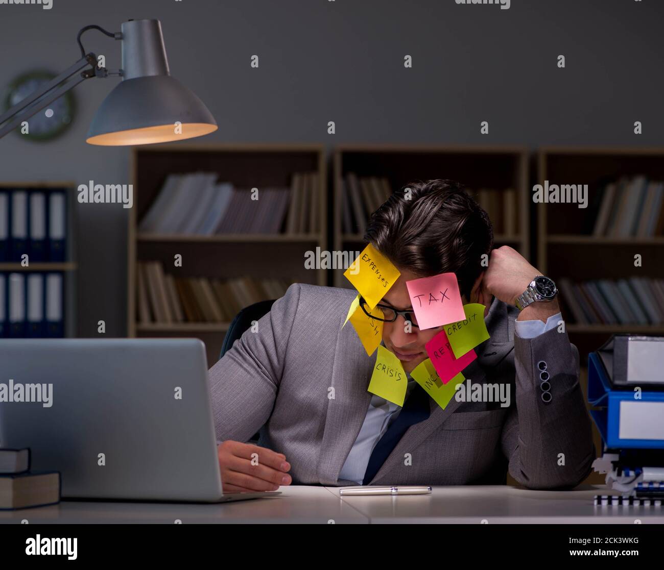The businessman staying late to sort out priorities Stock Photo - Alamy