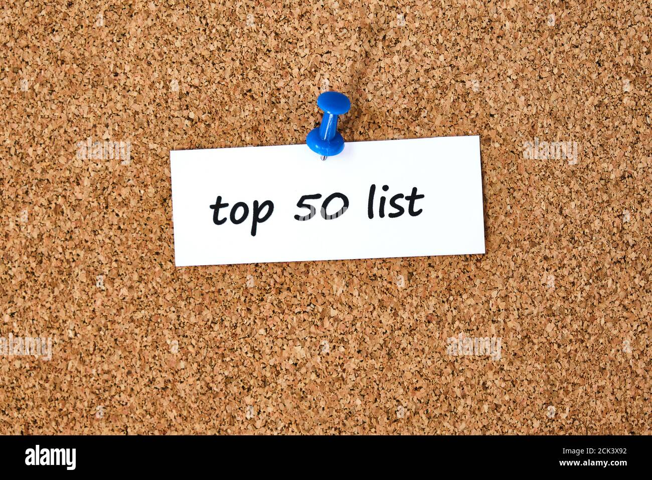Top 50 list. Text written on a piece of paper or note, cork board ...