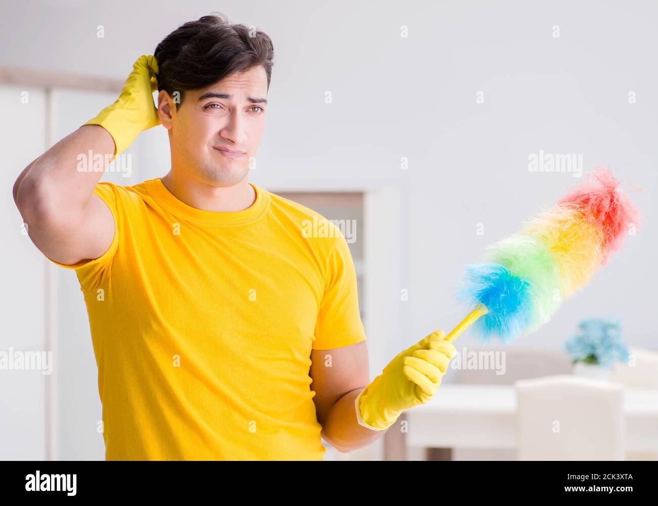 Man holding feather duster hi-res stock photography and images - Alamy