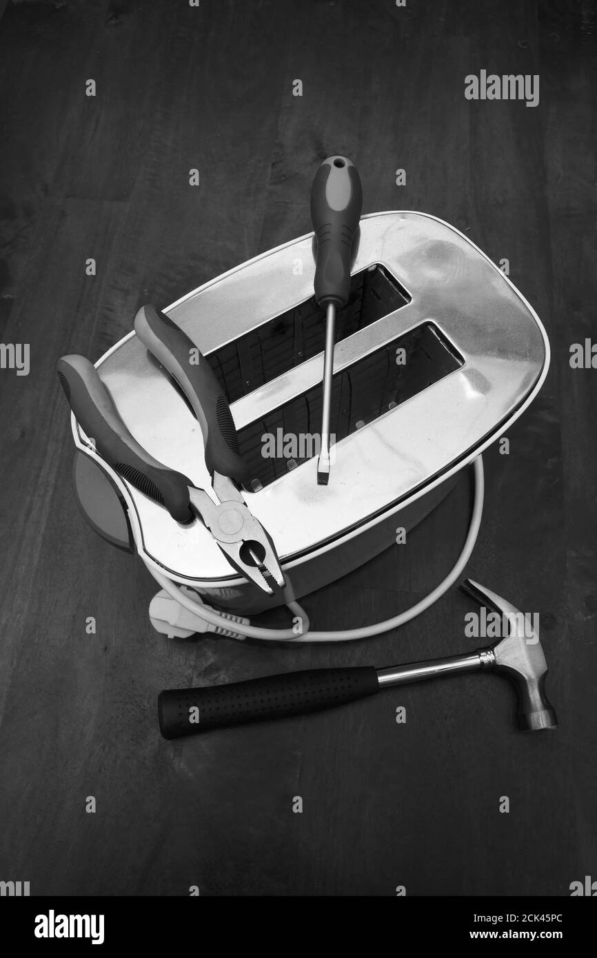 Broken toaster with some tools around for repairing it Stock Photo - Alamy
