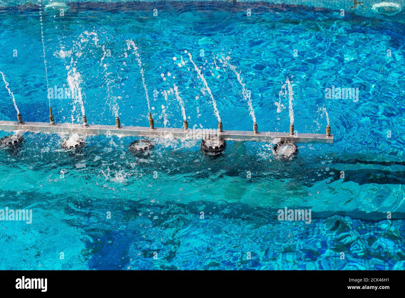 A water fountain sprinkling water in the view Stock Photo - Alamy