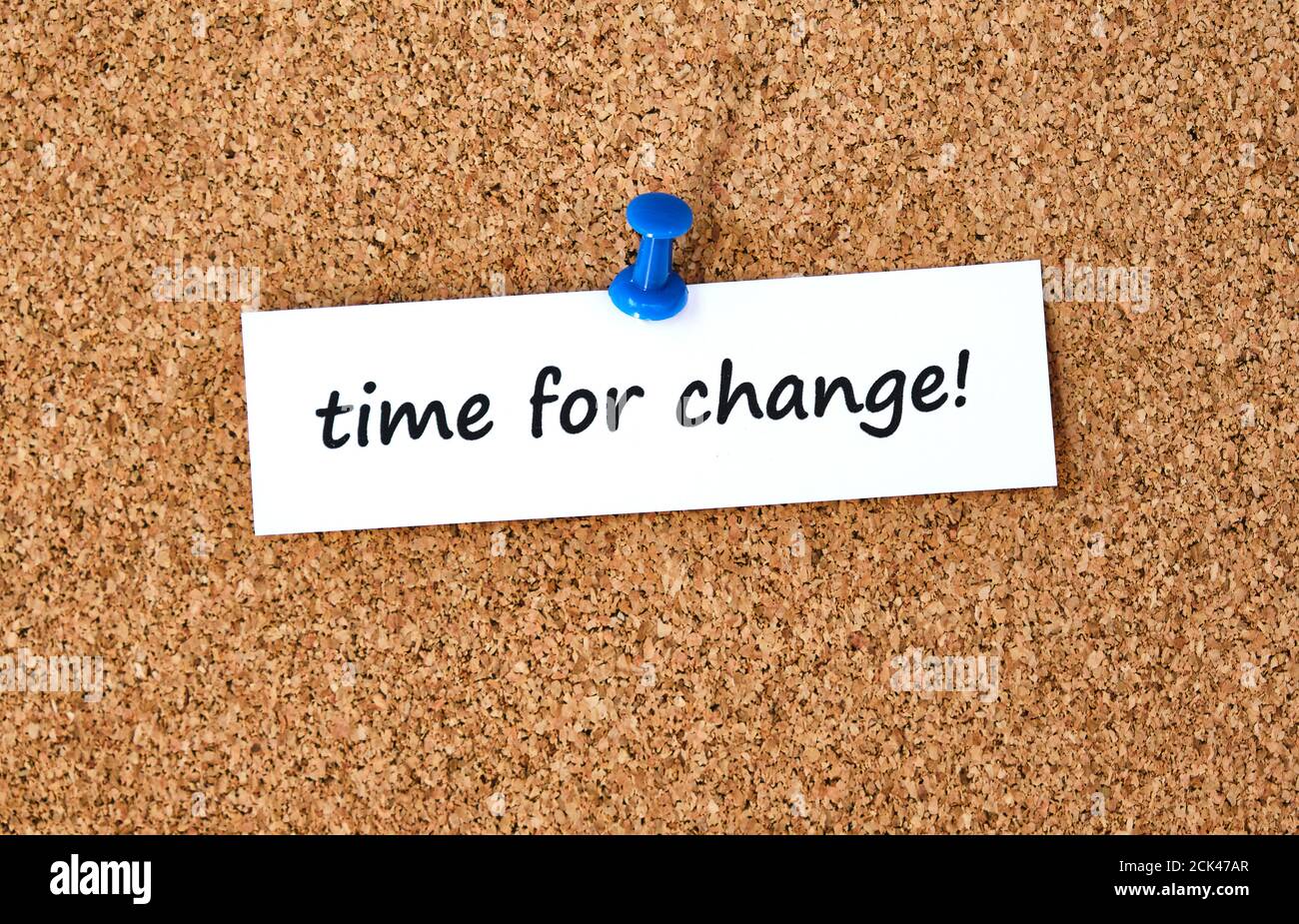 Time for change. Text written on a piece of paper or note, cork board ...