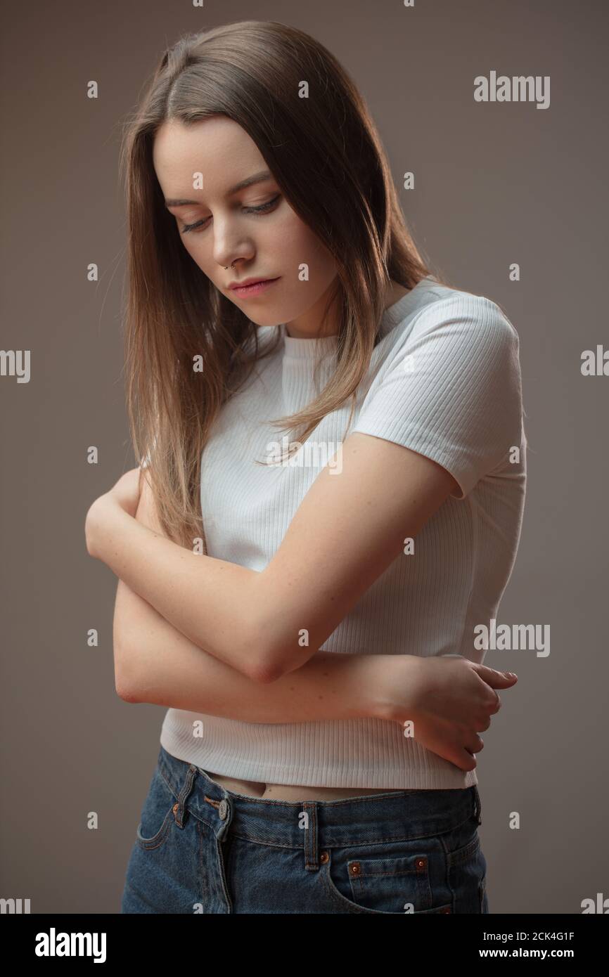 feeling of isolation. young helpless woman isolated on the brown ...