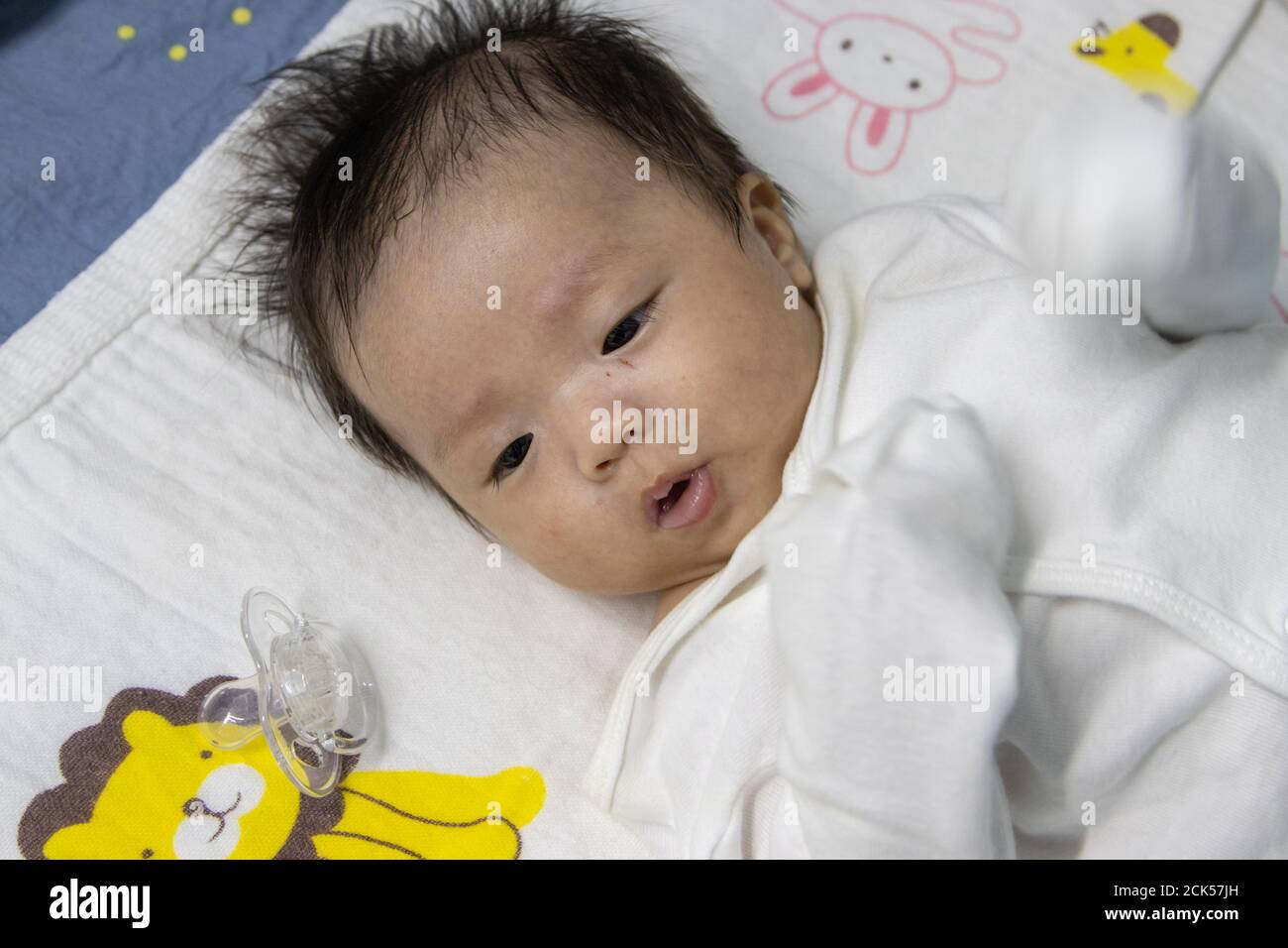 Portraiture image of two month old Asian Cute little baby boy lying on bed Stock Photo - Alamy