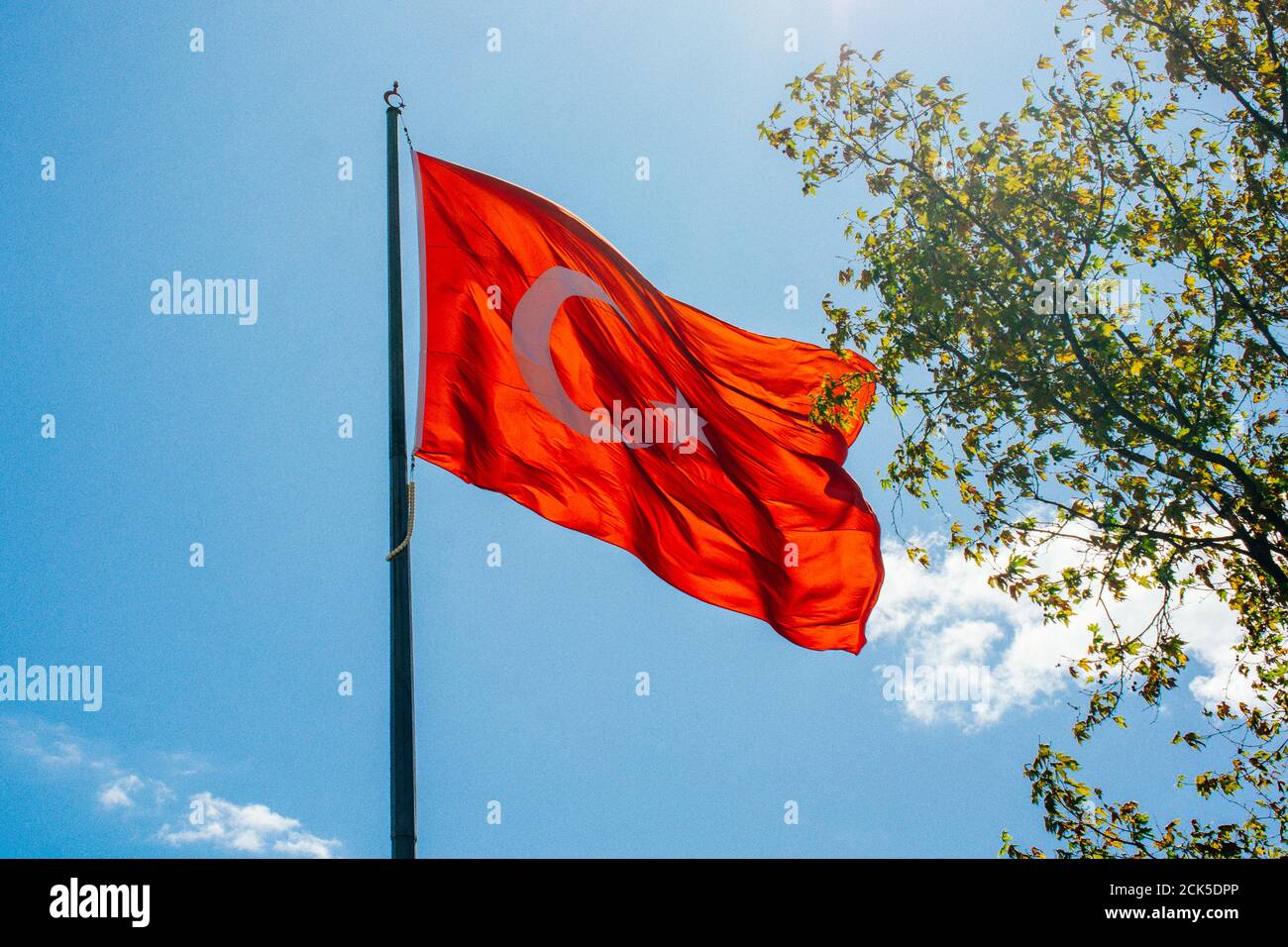 Turkish national flag with white star and moon on a pole in sky Stock ...