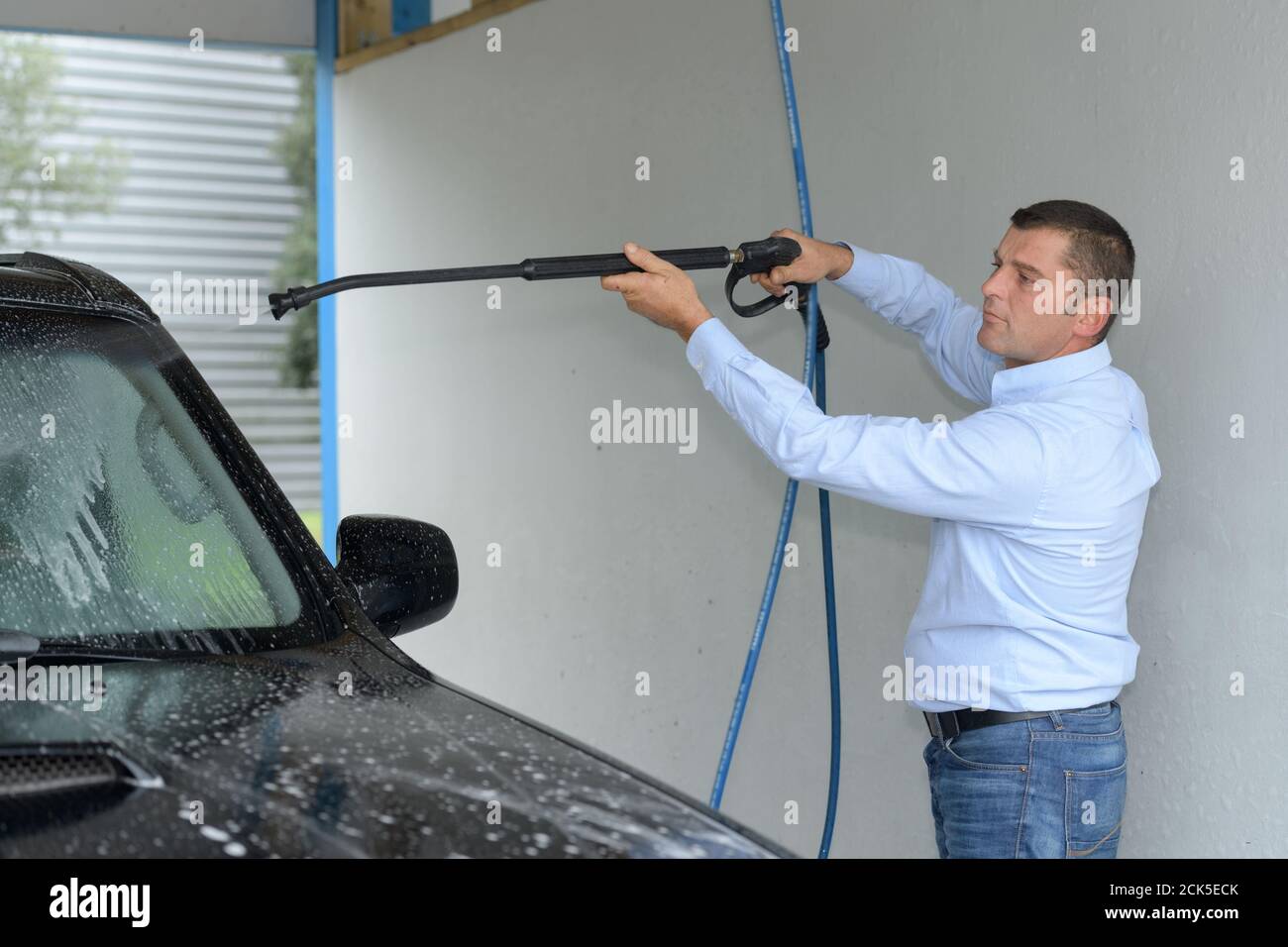 portrait of man washing the car Stock Photo - Alamy