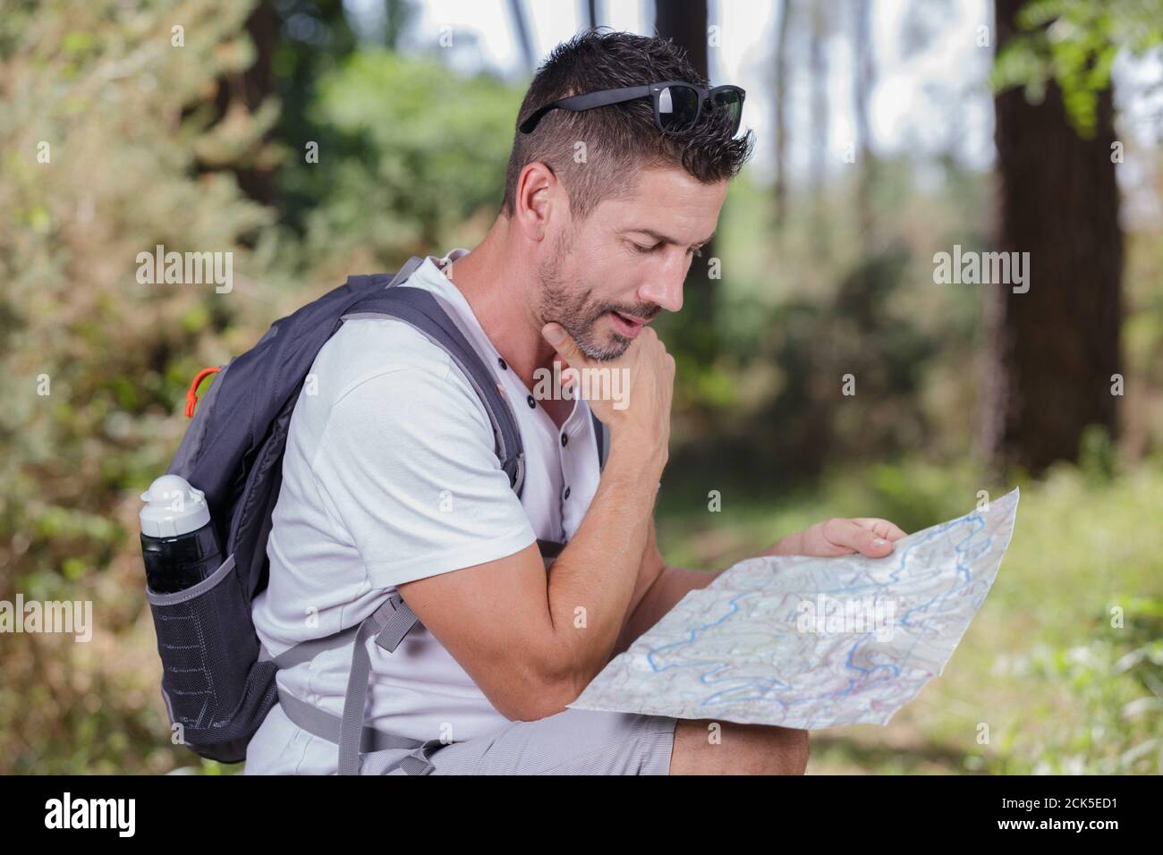 hiker with map exploring wilderness on trekking adventure Stock Photo ...