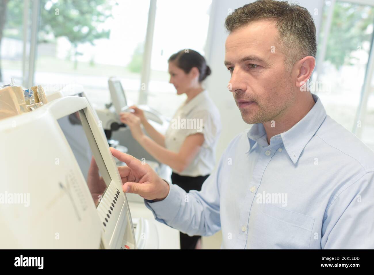 side view portrait of man pressing buttons on control panel Stock Photo ...
