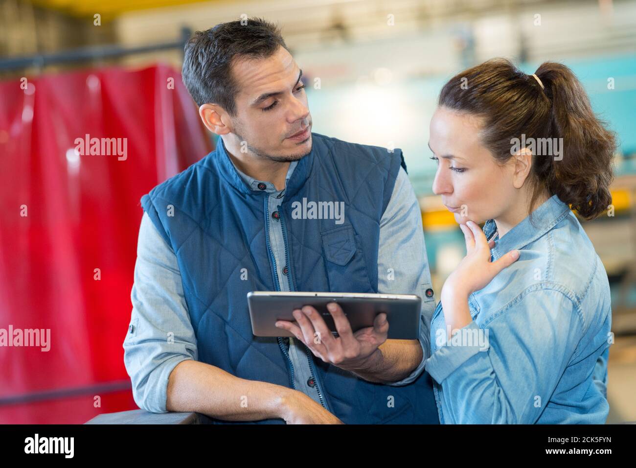 managers looking a tablet in warehouse Stock Photo - Alamy
