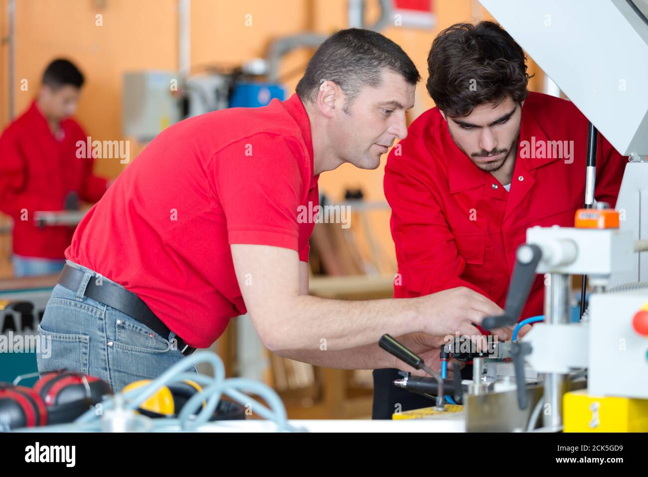 portrait of factory staff operating machinery Stock Photo - Alamy