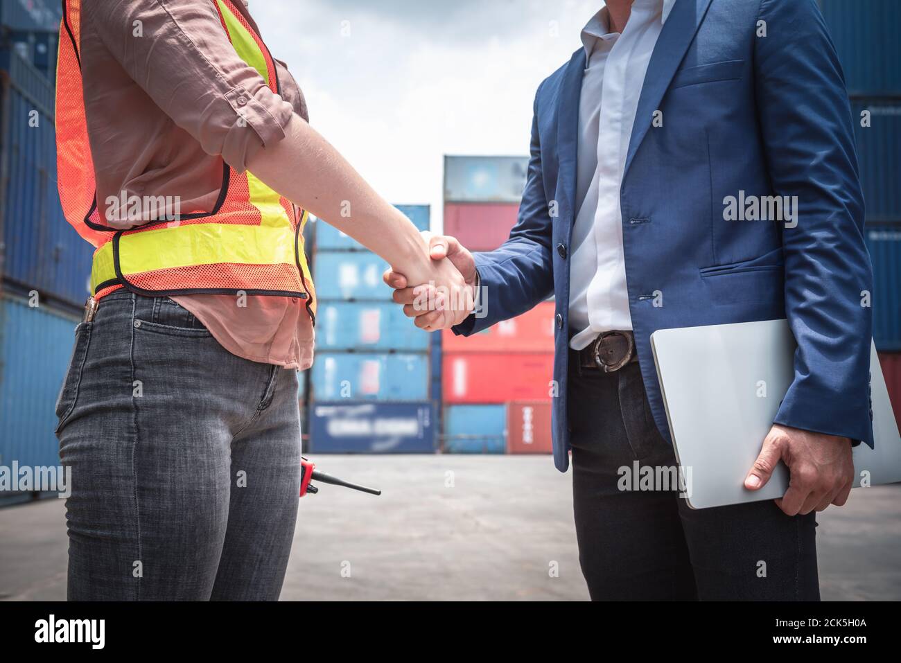 Businessman and Container Shipping Worker Handshake Together for ...