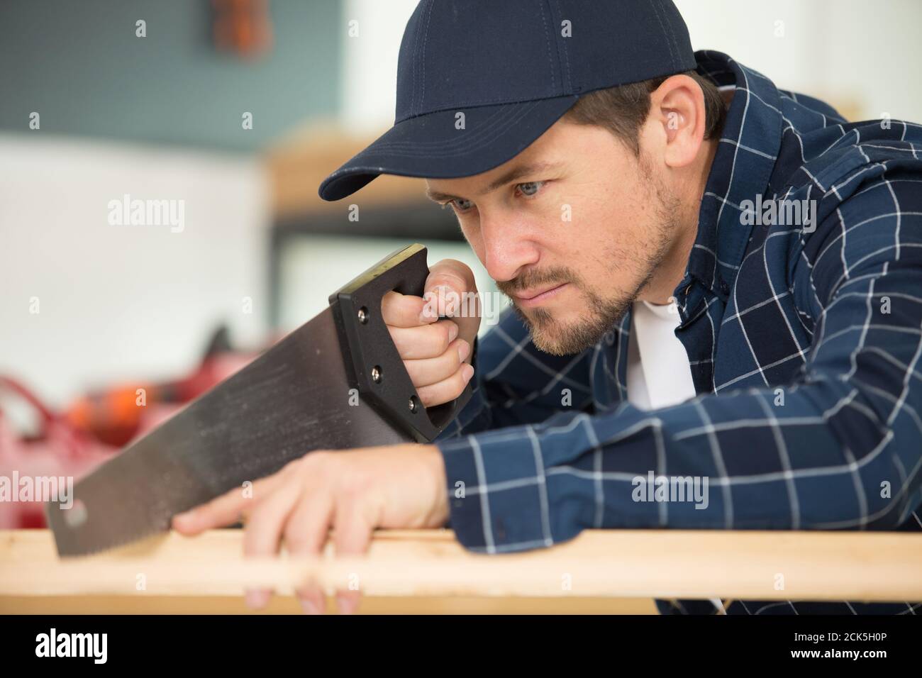 a young man using handsaw Stock Photo - Alamy