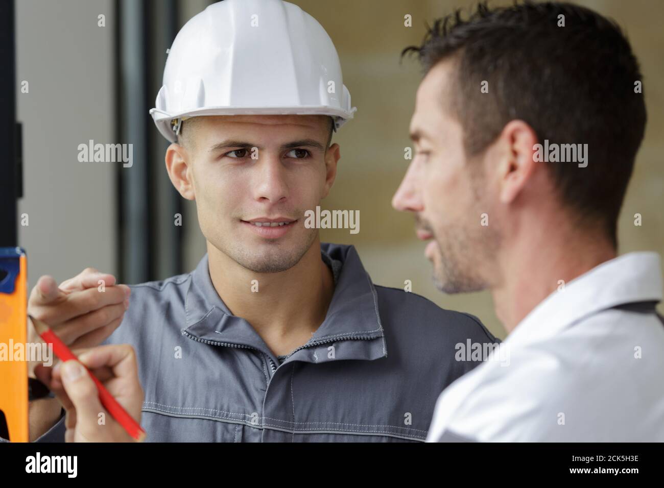 construction workers installing window in house Stock Photo - Alamy