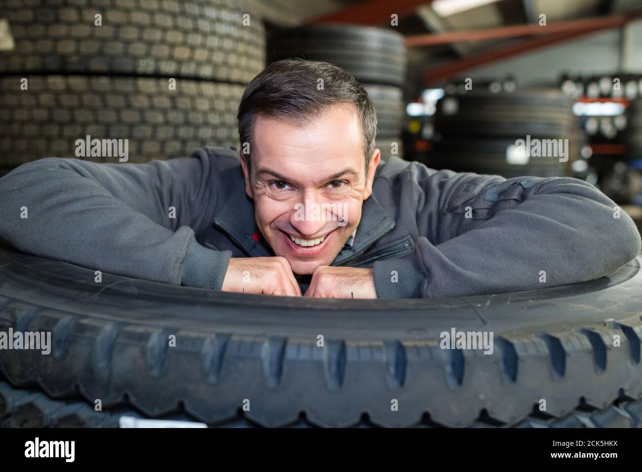 happy mechanic ready to change wheels Stock Photo - Alamy