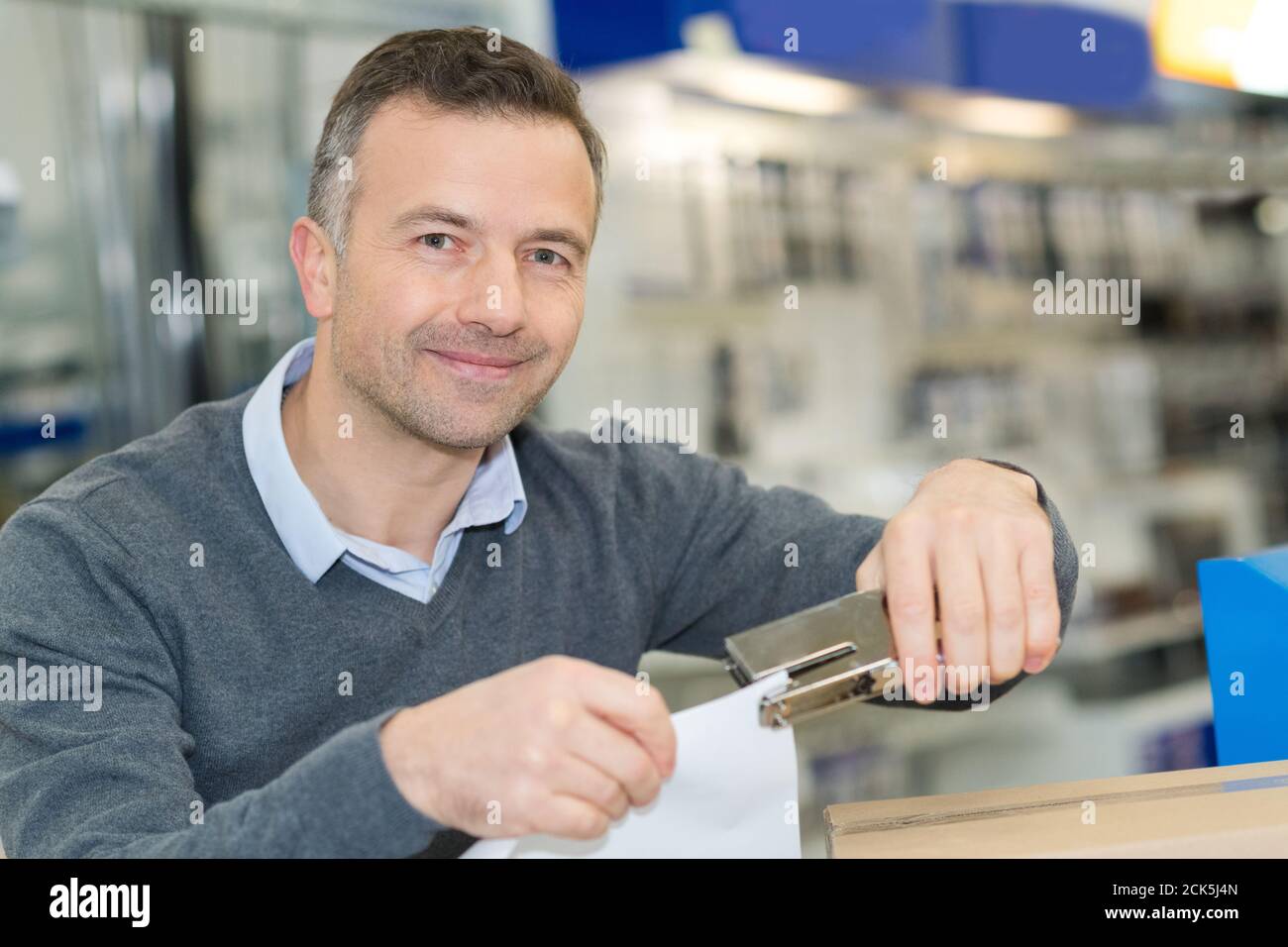 man with a stapler paper Stock Photo - Alamy