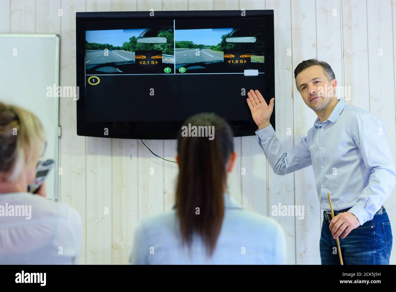instructor teaches his scholars by using tv Stock Photo - Alamy