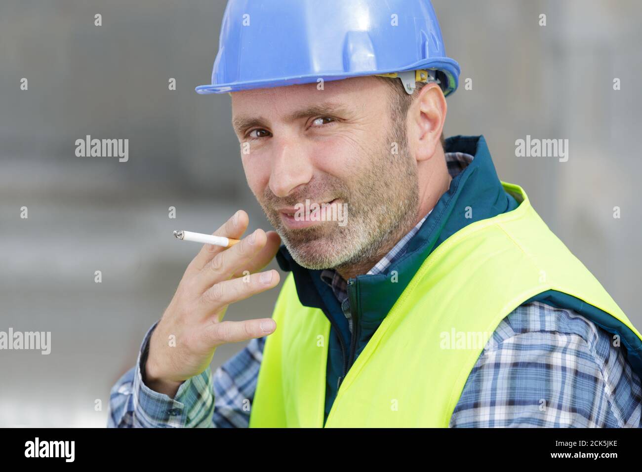 builder smoking in a construction site Stock Photo - Alamy