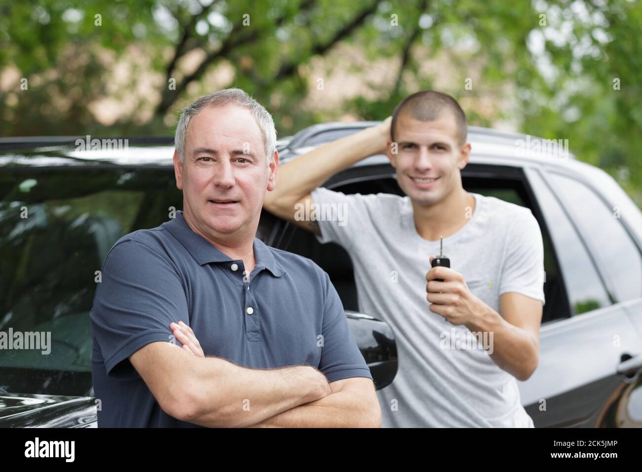 Man standing beside car hi-res stock photography and images - Alamy