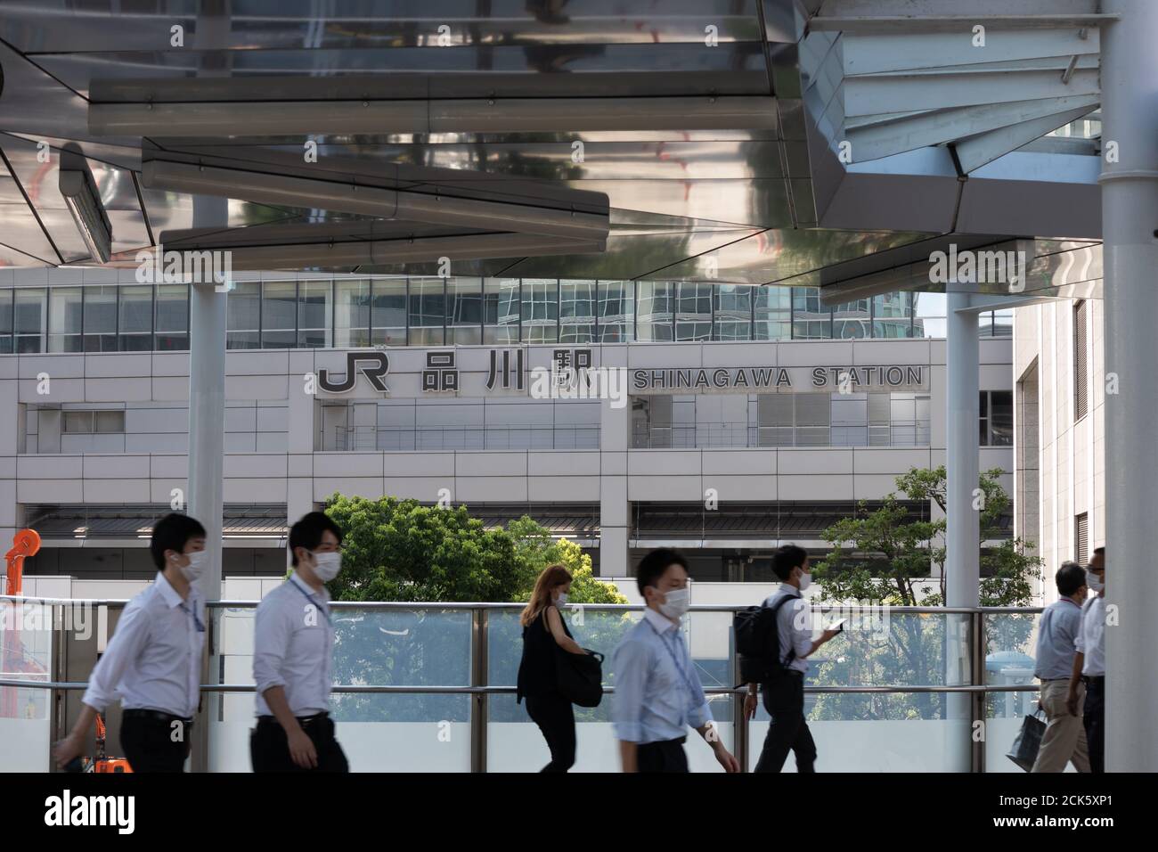TOKYO, JAPAN - September 15, 2020 : Japanese walking across the walkway ...