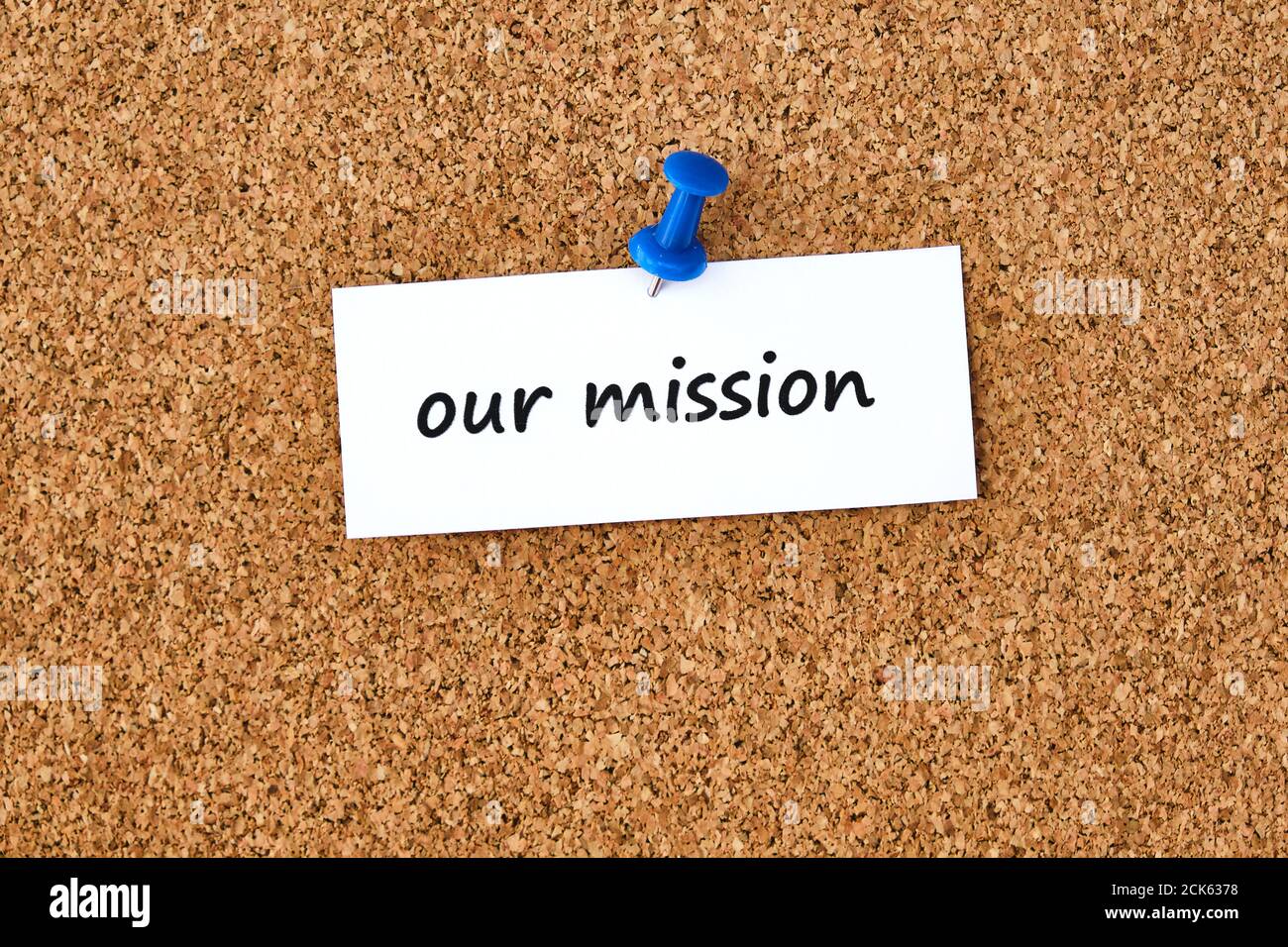 Our mission. Text written on a piece of paper or note, cork board ...