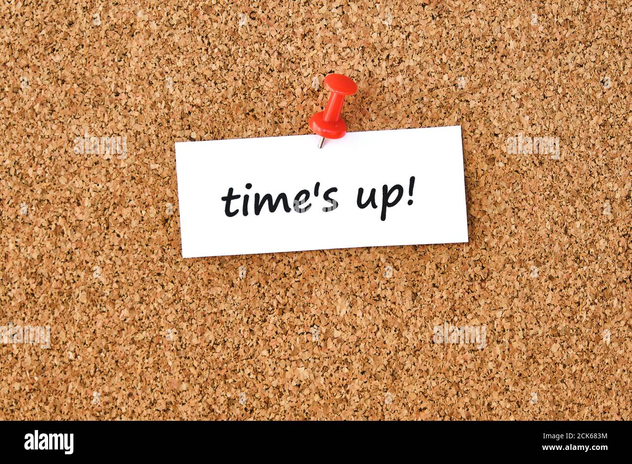 Time's up. Text written on a piece of paper or note, cork board ...