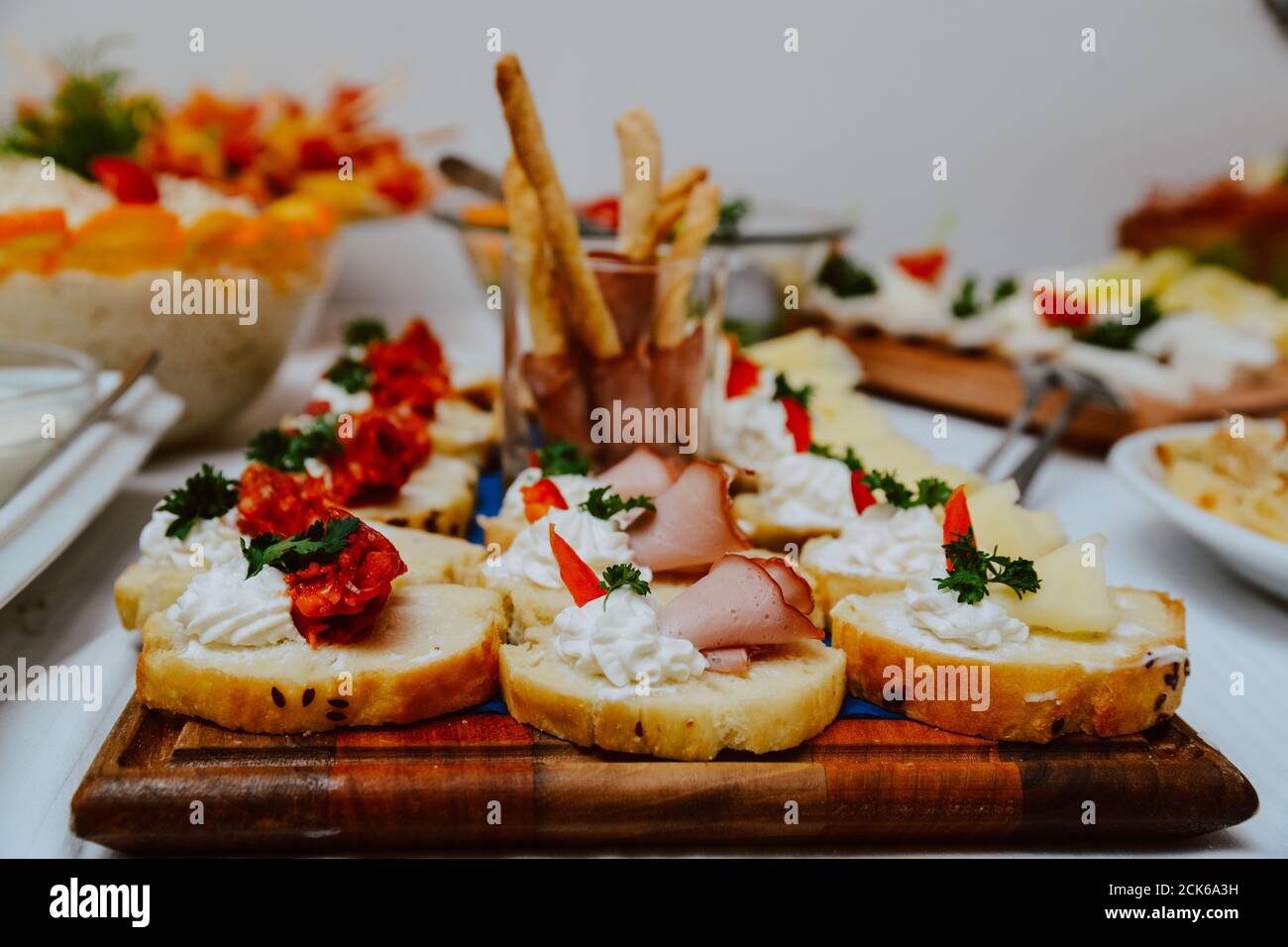 Small canapes sandwiches served on a plate at the celebration. Snack ...