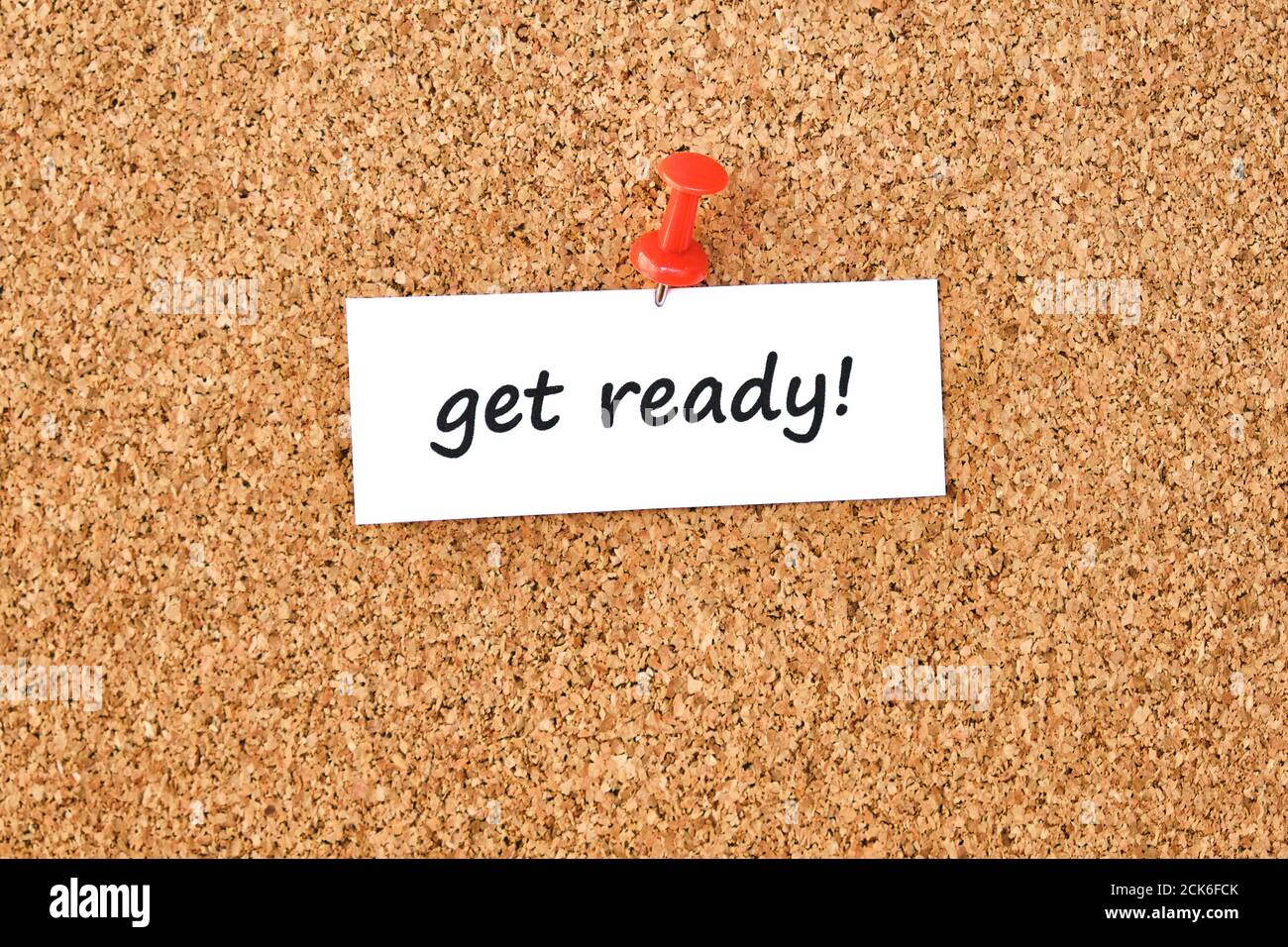 Get ready. Text written on a piece of paper or note, cork board ...