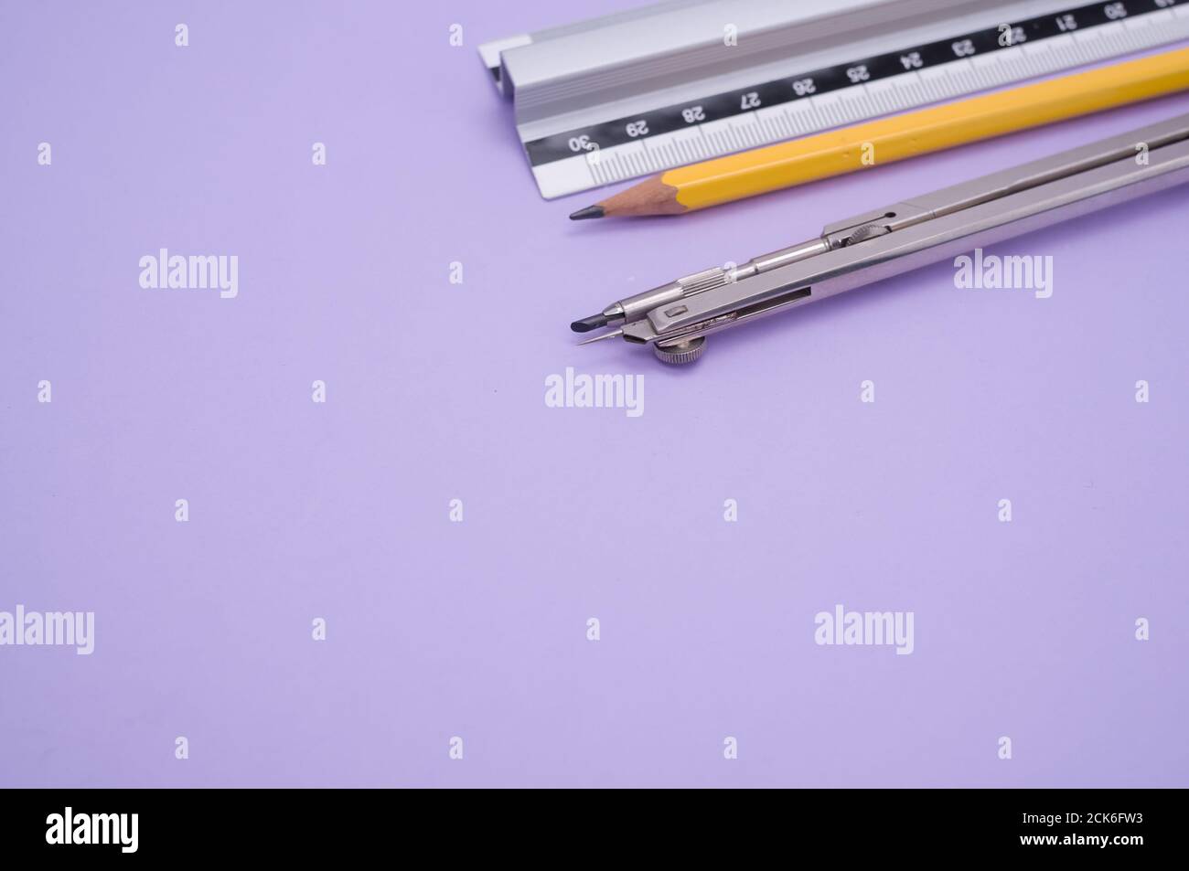 Set of technical drawing tools on a purple background with a copy space ...