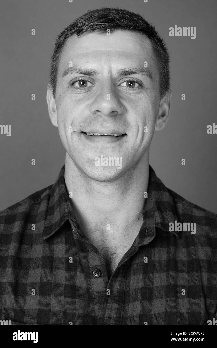 Handsome man with short hair against gray background Stock Photo - Alamy