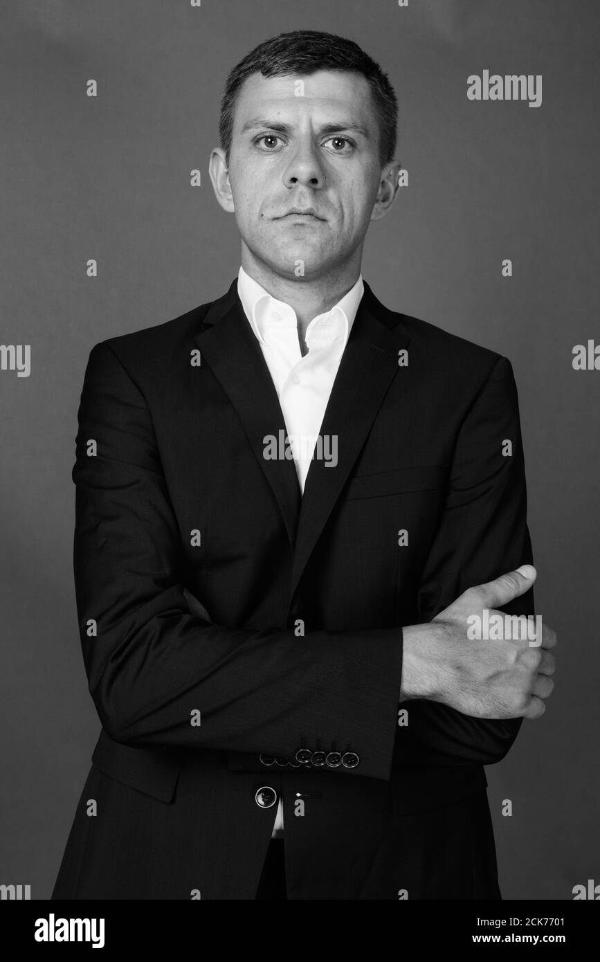 Handsome businessman with short hair against gray background Stock ...