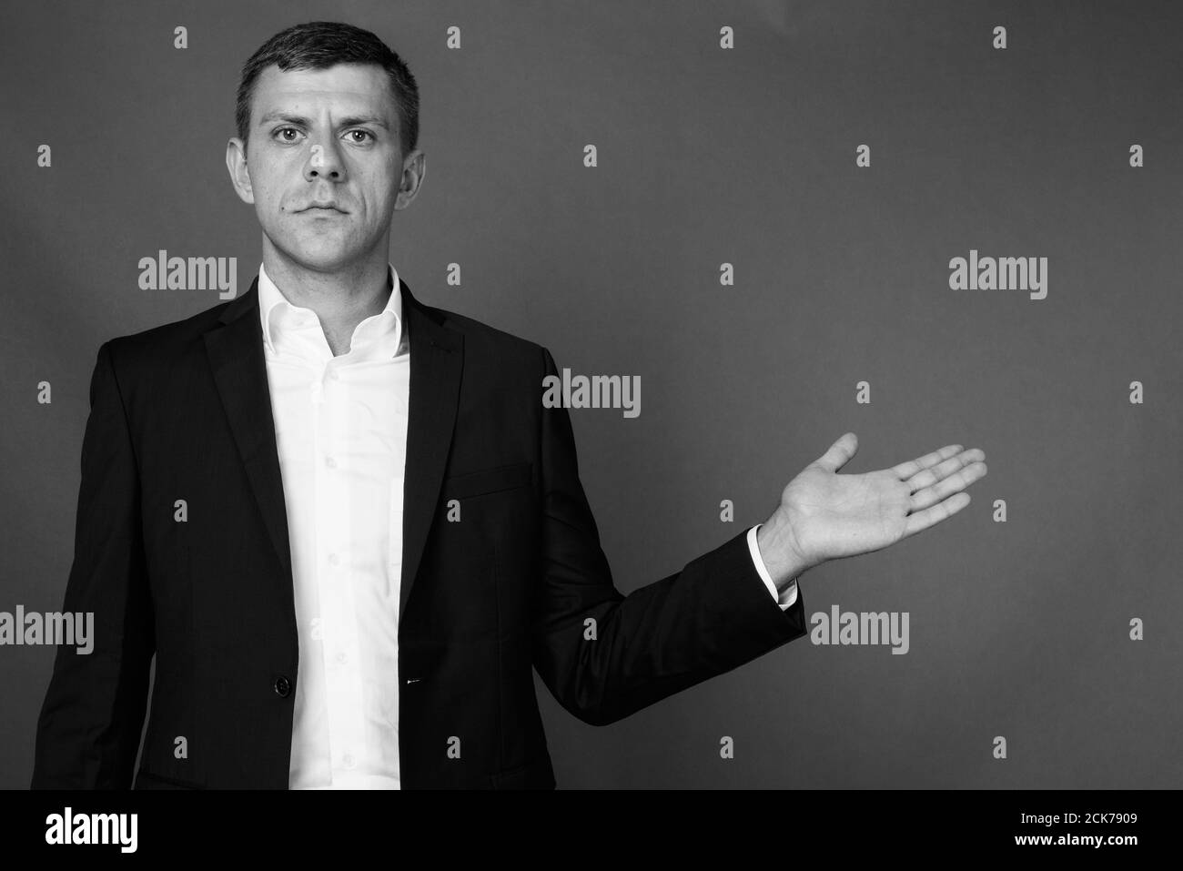 Handsome businessman with short hair against gray background Stock ...