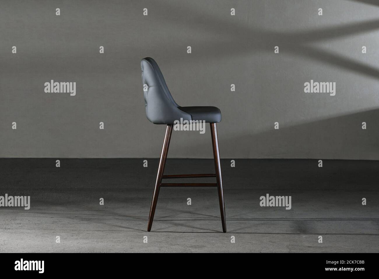 Closeup of an armless chair with a concave back, loft-style furniture ...