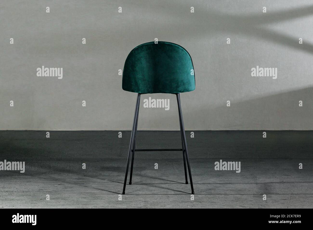 Closeup of a high, armless chair with a concave back, loft-style ...