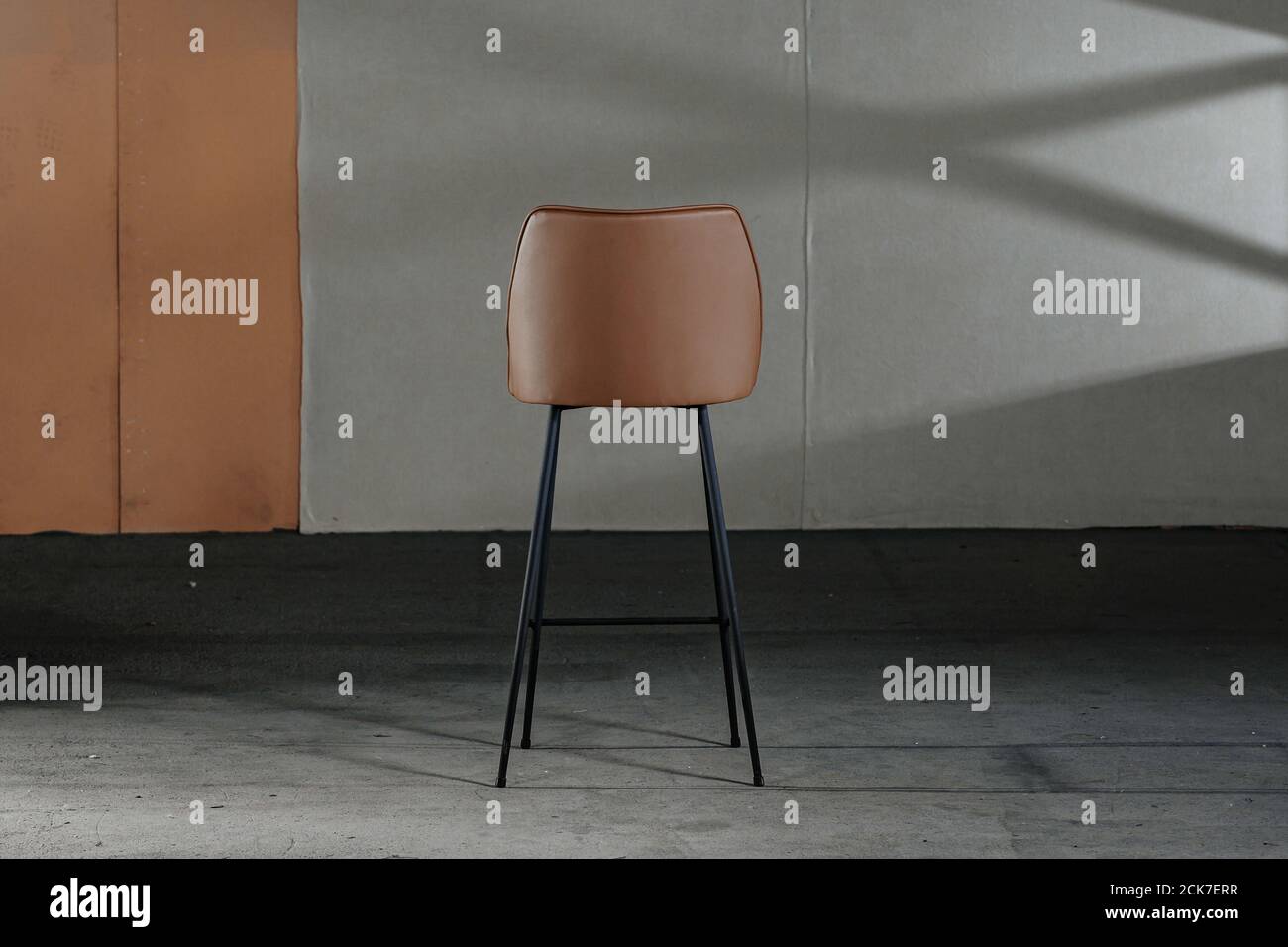Closeup of an armless chair with a concave back, loft-style furniture ...