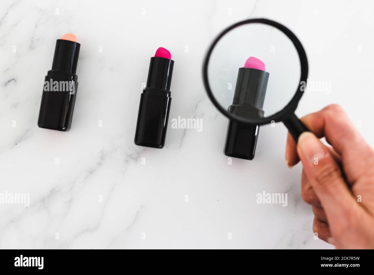 analyzing make-up ingredients concept, set of lipsticks with magnifying ...
