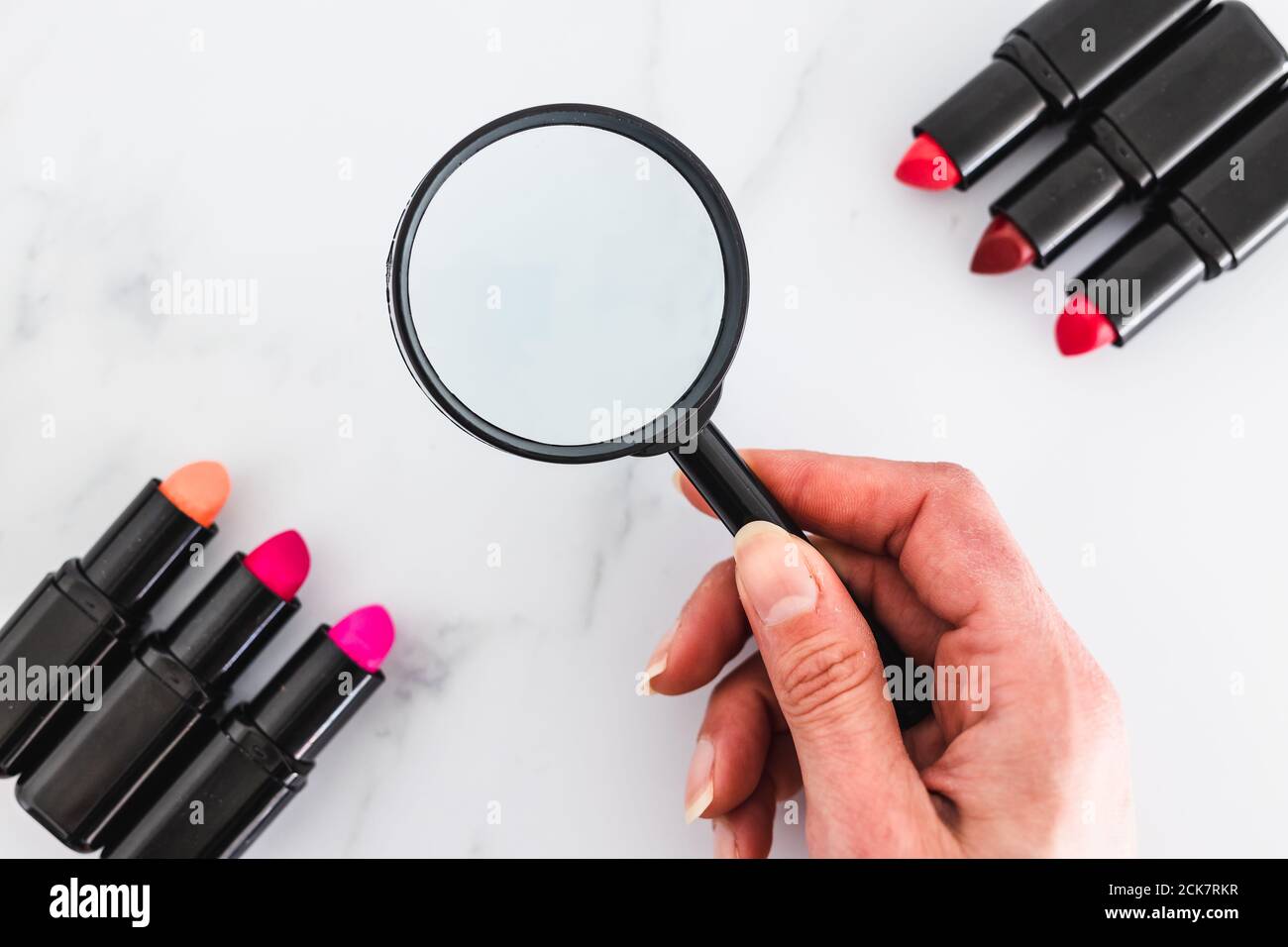 analyzing make-up ingredients concept, set of lipsticks with magnifying ...
