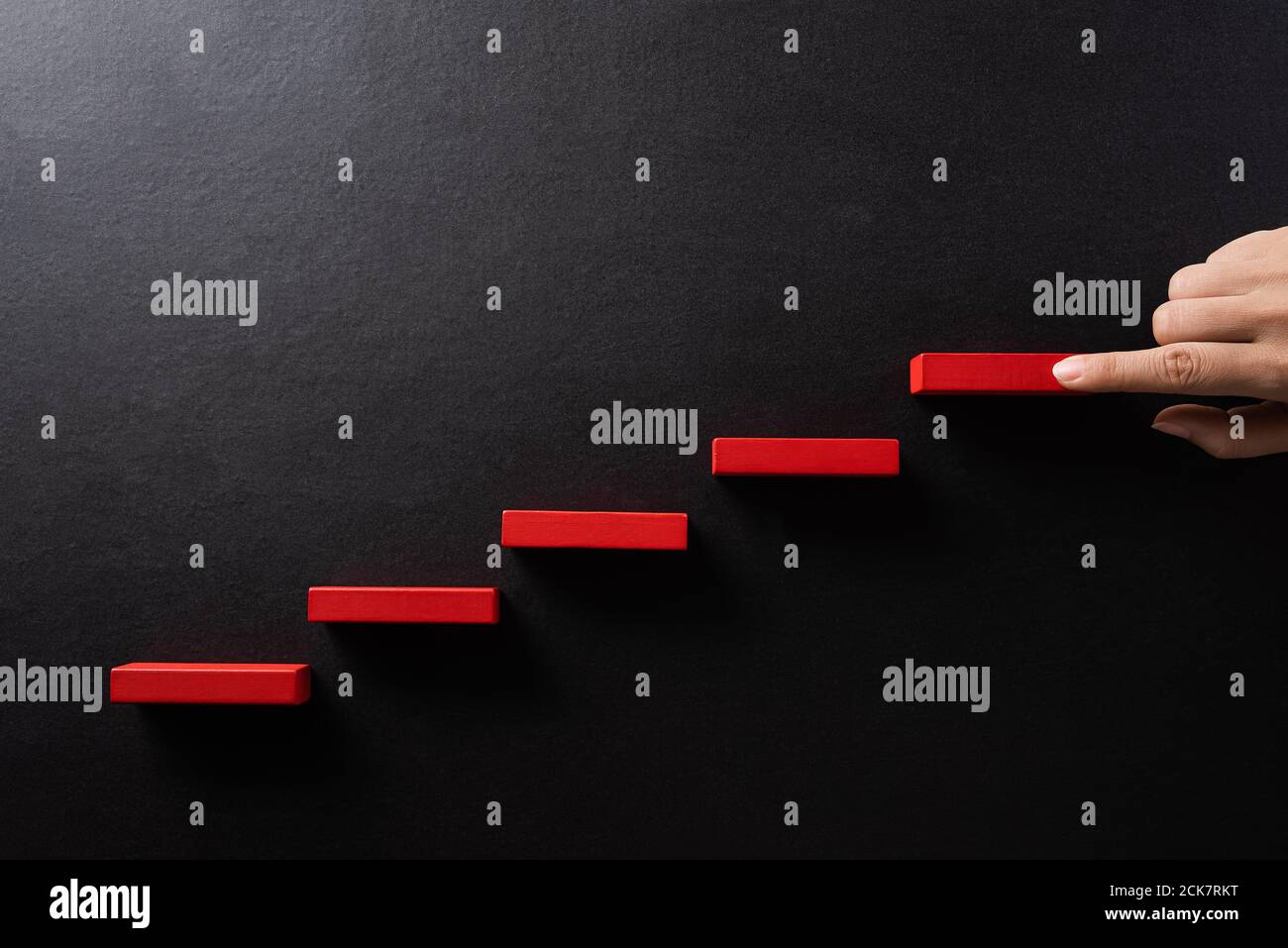 Concept of building success foundation. Women hand put red wooden block ...