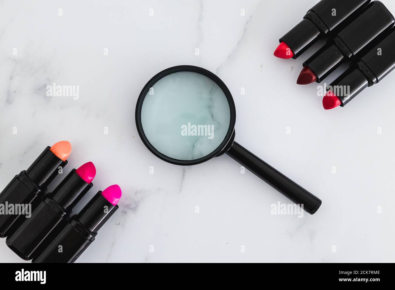 analyzing make-up ingredients concept, set of lipsticks with magnifying ...