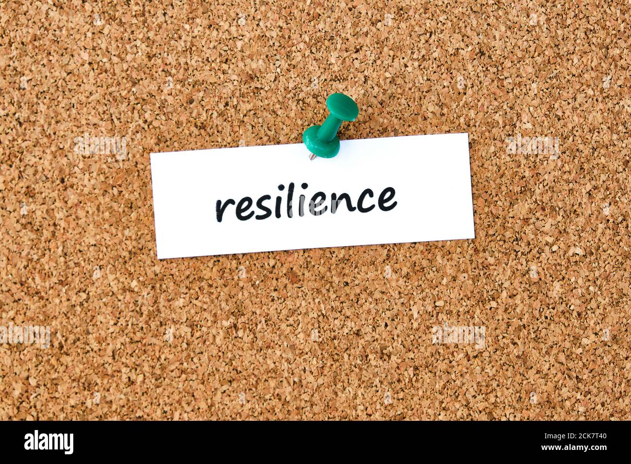 Resilience. Word written on a piece of paper or note, cork board ...