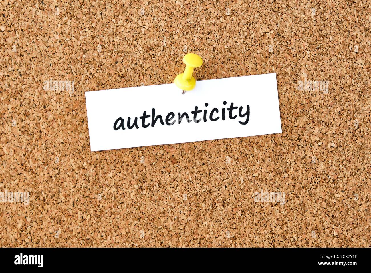 Authenticity. Word written on a piece of paper or note, cork board ...
