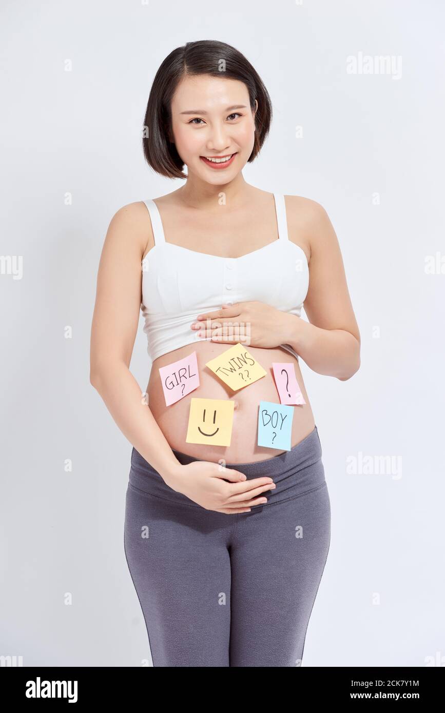 Asian pregnant woman with sticky note on her belly Stock Photo - Alamy