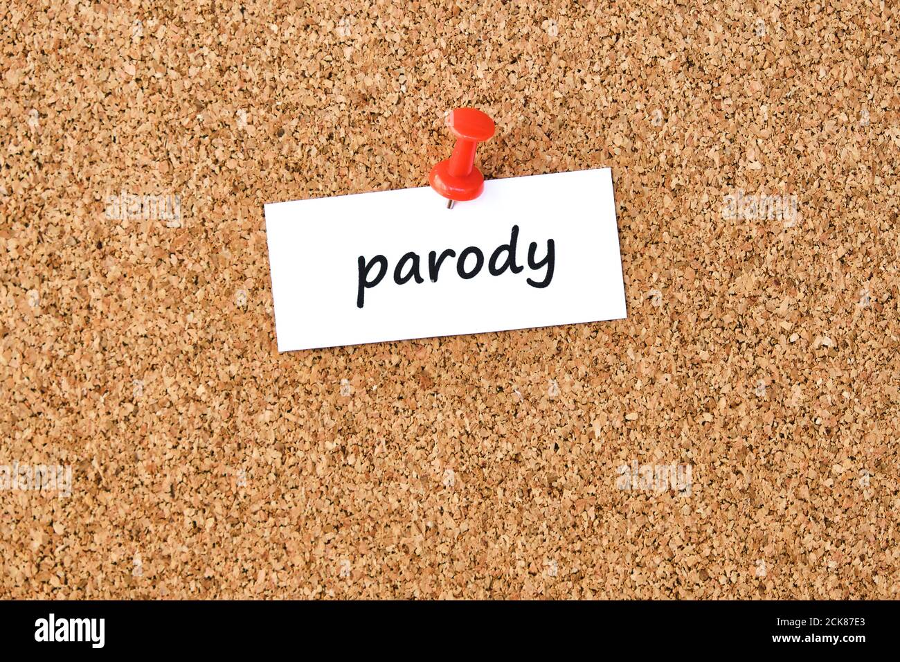 Parody. Word written on a piece of paper or note, cork board background ...