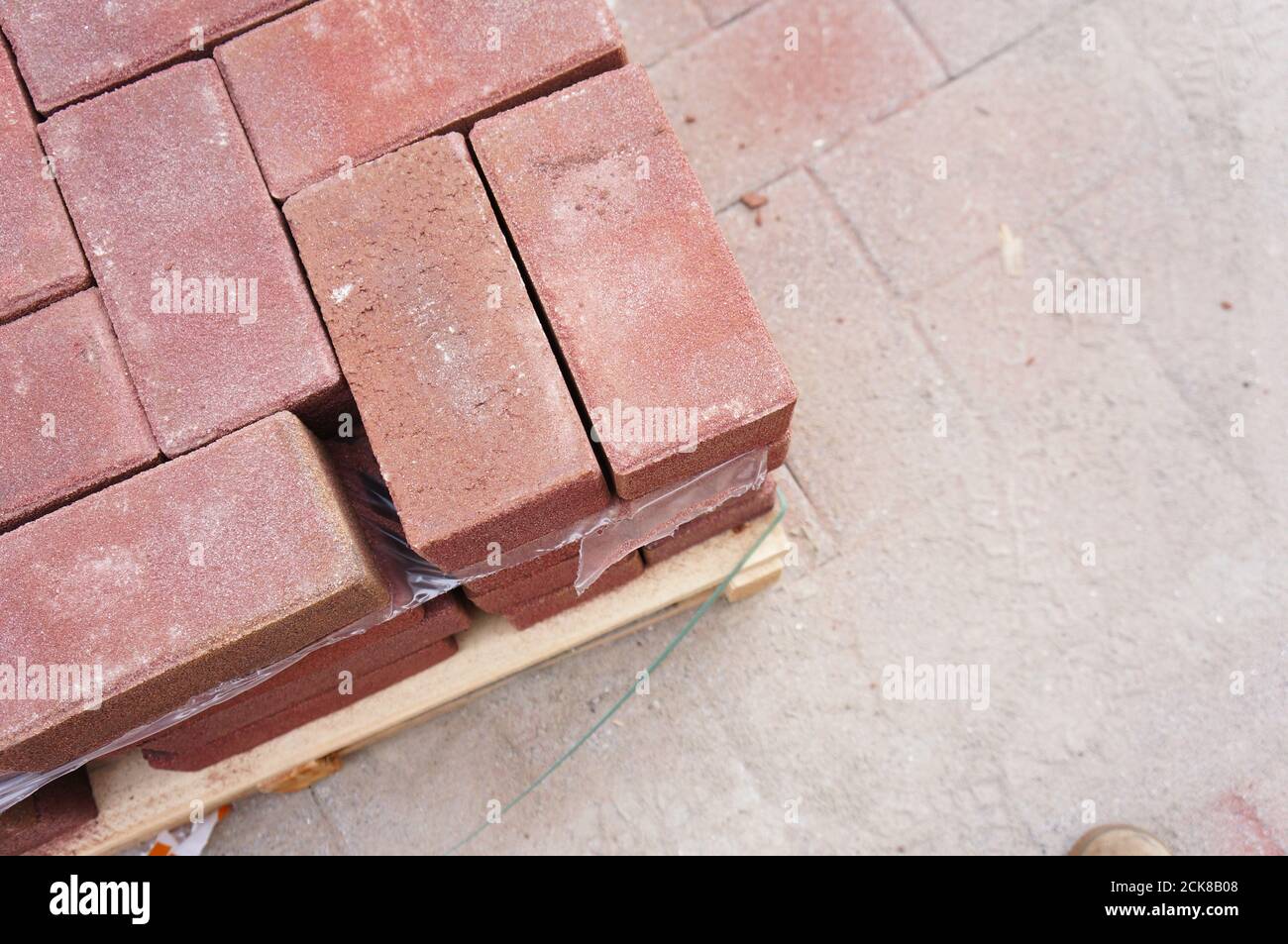 Red bricks on the wooden pallet at a construction area Stock Photo - Alamy